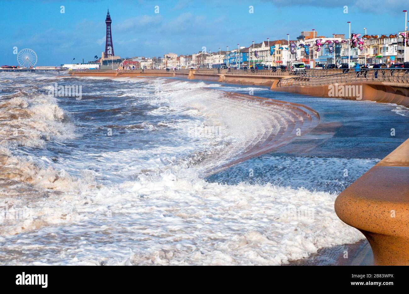 View of waves coming in at high tide and curve of the new sea wall with ...
