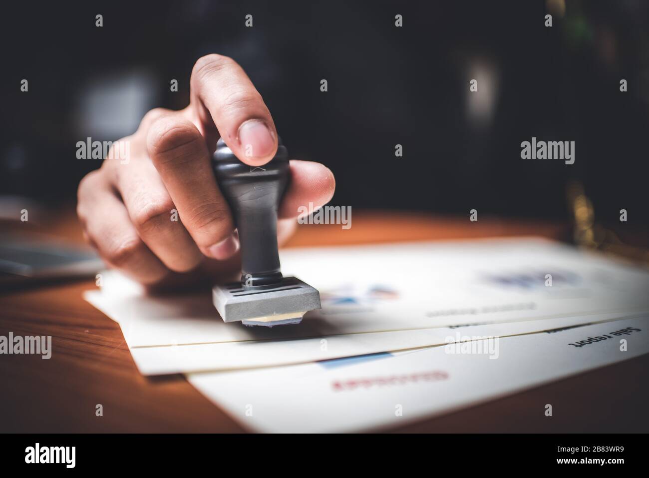 Close-up Of A Person's Hand Stamping With Approved Stamp On Text ...