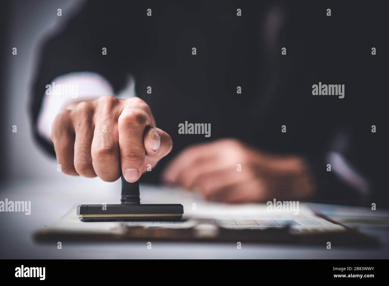 Close-up Of A Person's Hand Stamping With Approved Stamp On Text ...