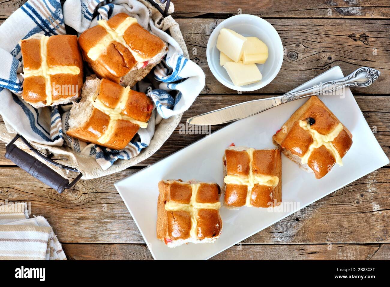 Easter Hot Cross Buns, overhead scene with basket and plate on rustic ...