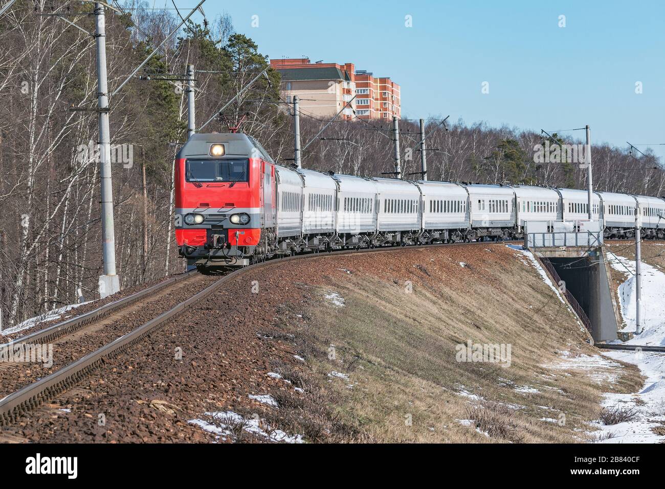 Passenger train approaches to the station Stock Photo - Alamy