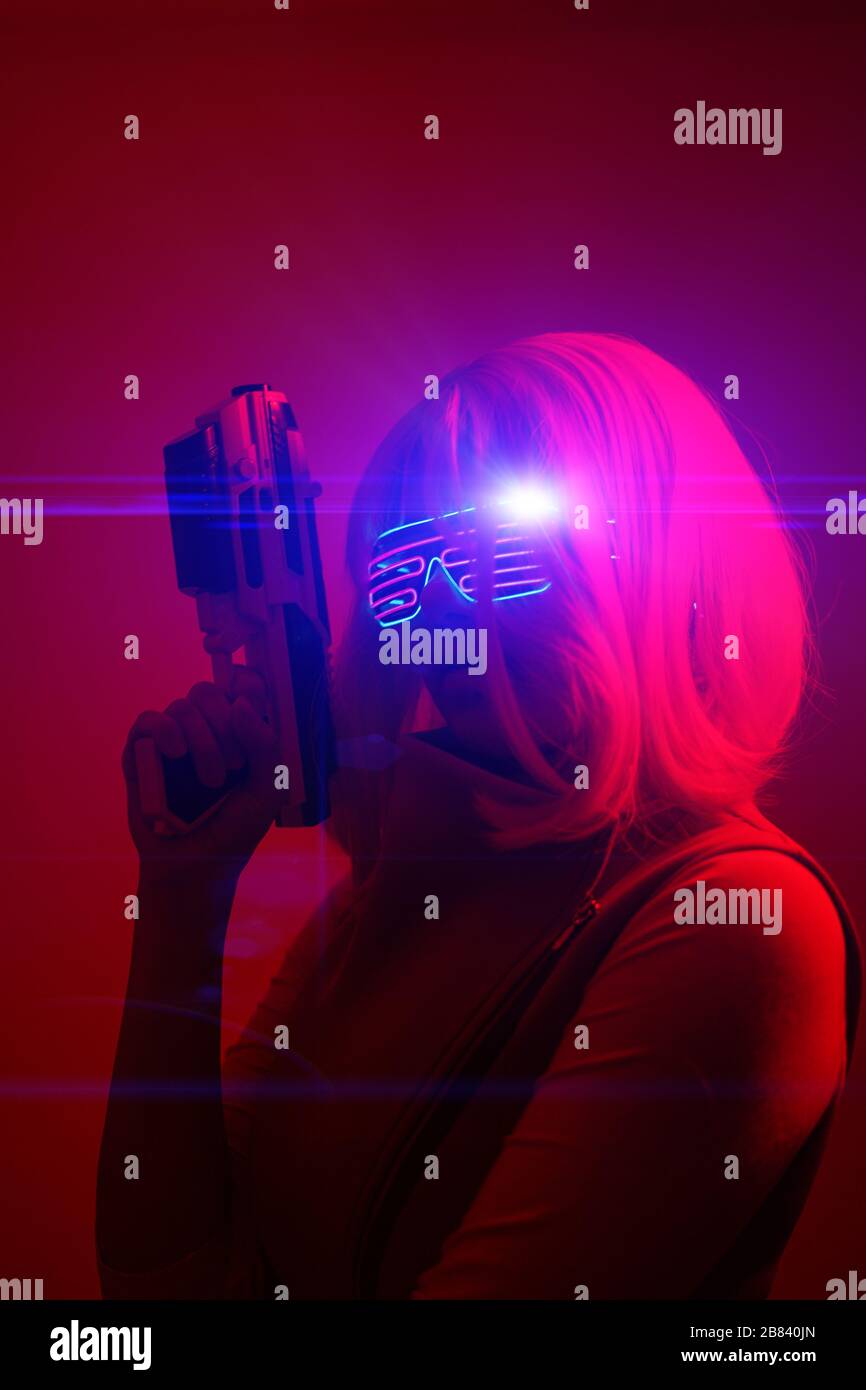 Girl with blaster in the futuristic battle. Concept virtual reality ...