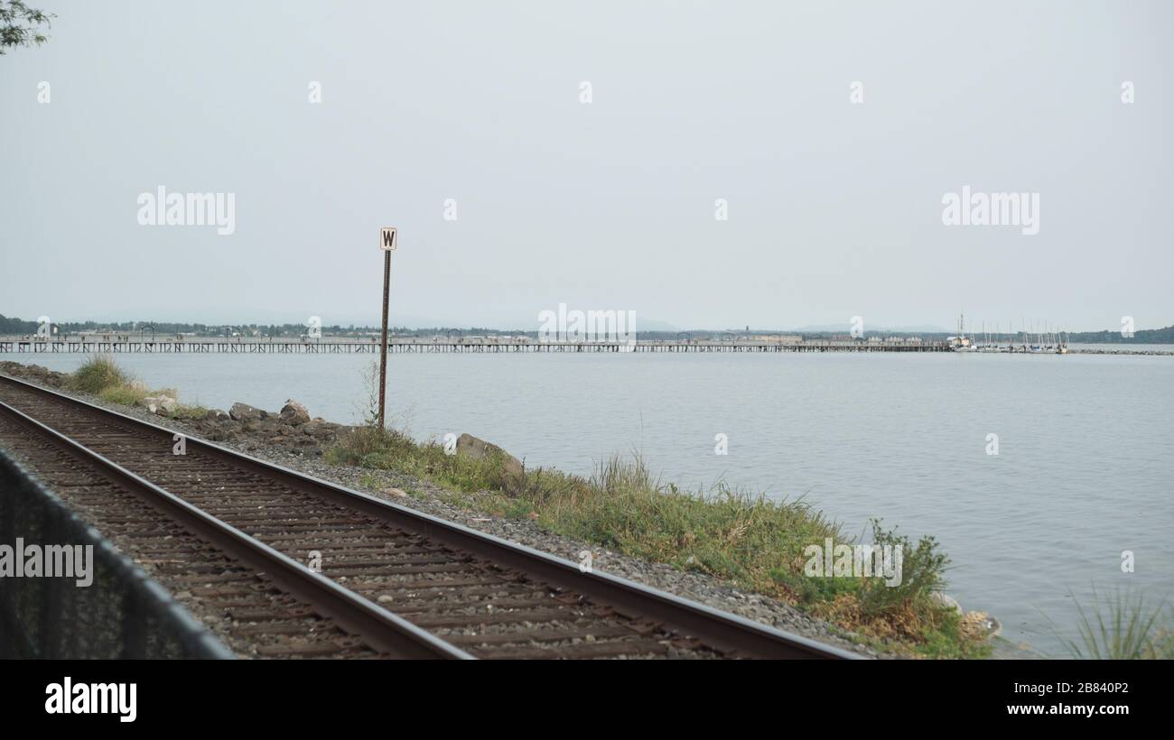Horizon line of a pier near a train track in White Rock BC Stock Photo ...