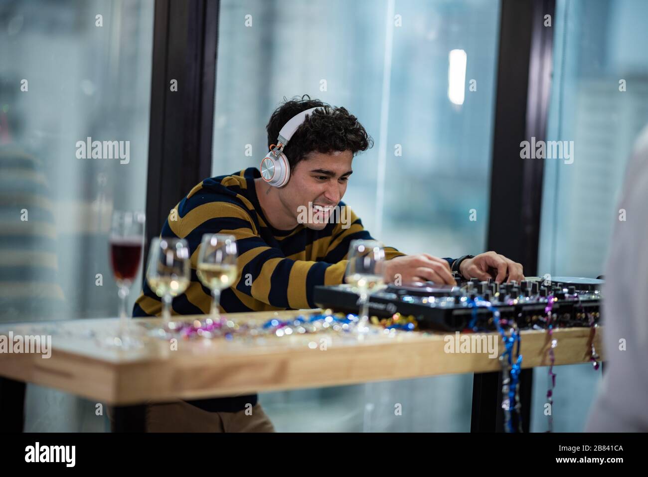 DJ working with Digital Mixer & Controller in celebration party Stock ...