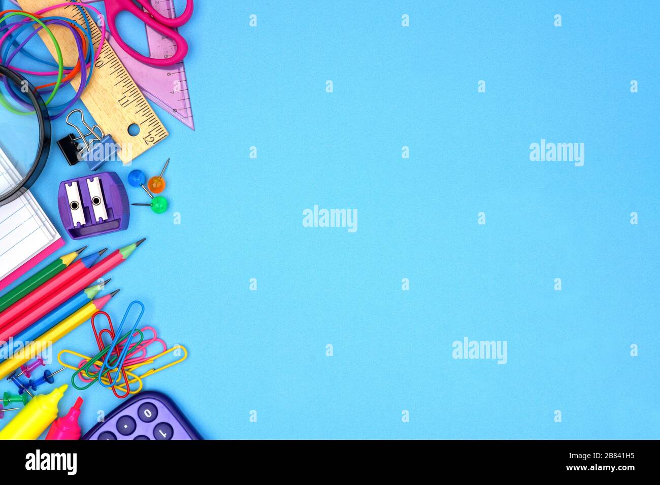 School supplies side border against a blue paper background Stock Photo - Alamy