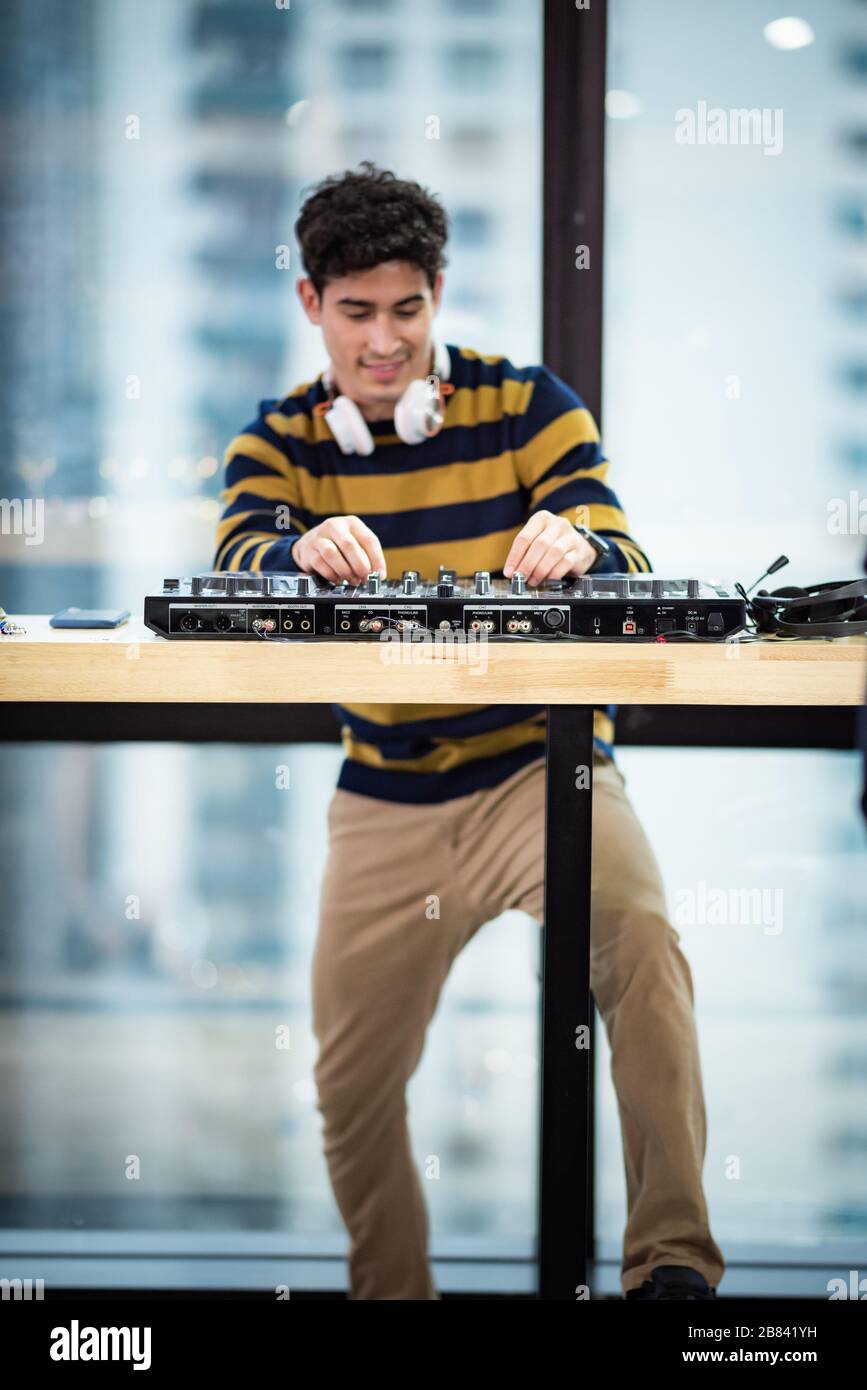 DJ working with Digital Mixer & Controller in celebration party Stock ...