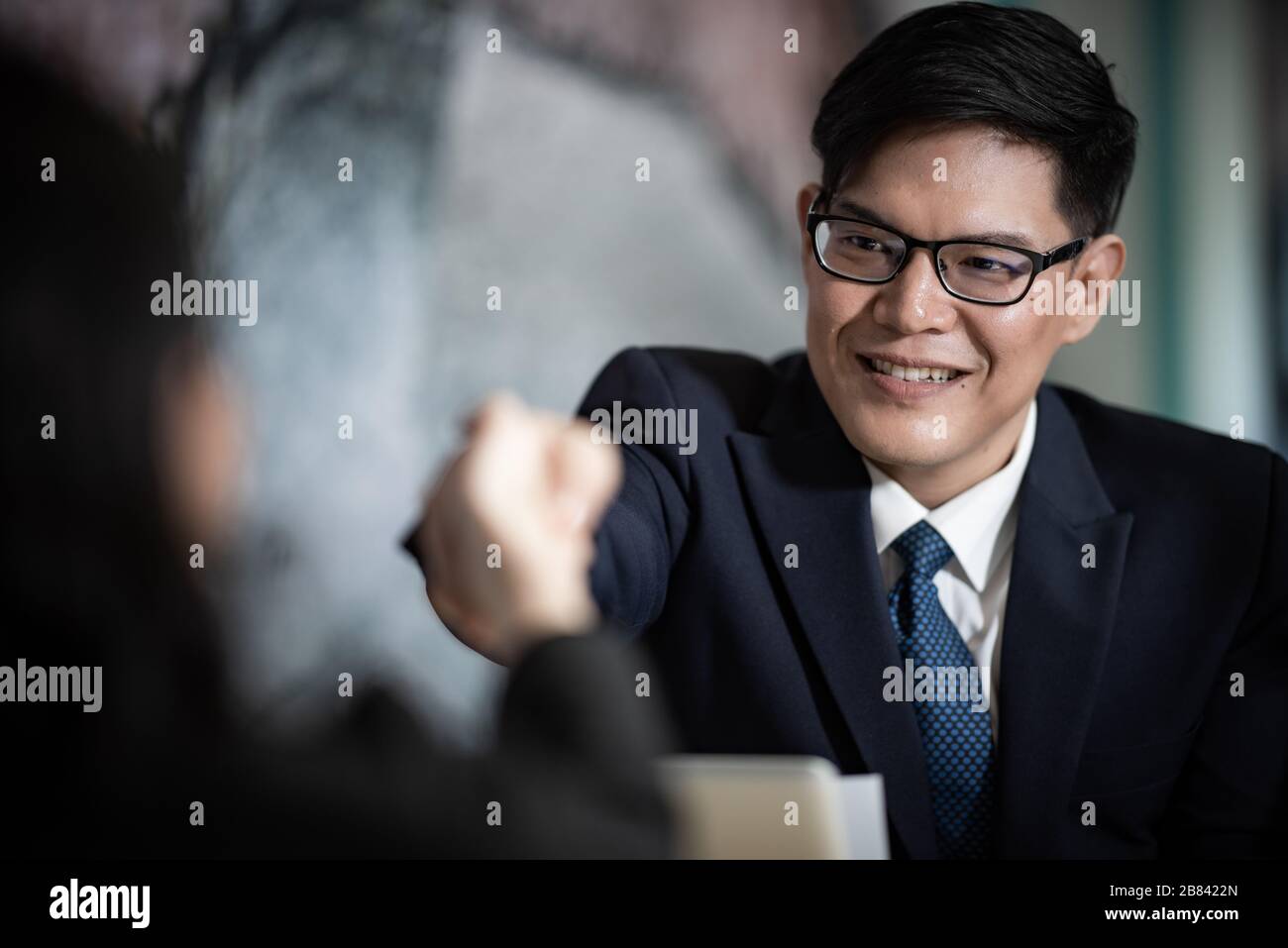 Successful job interview with boss and employee handshaking Stock Photo ...