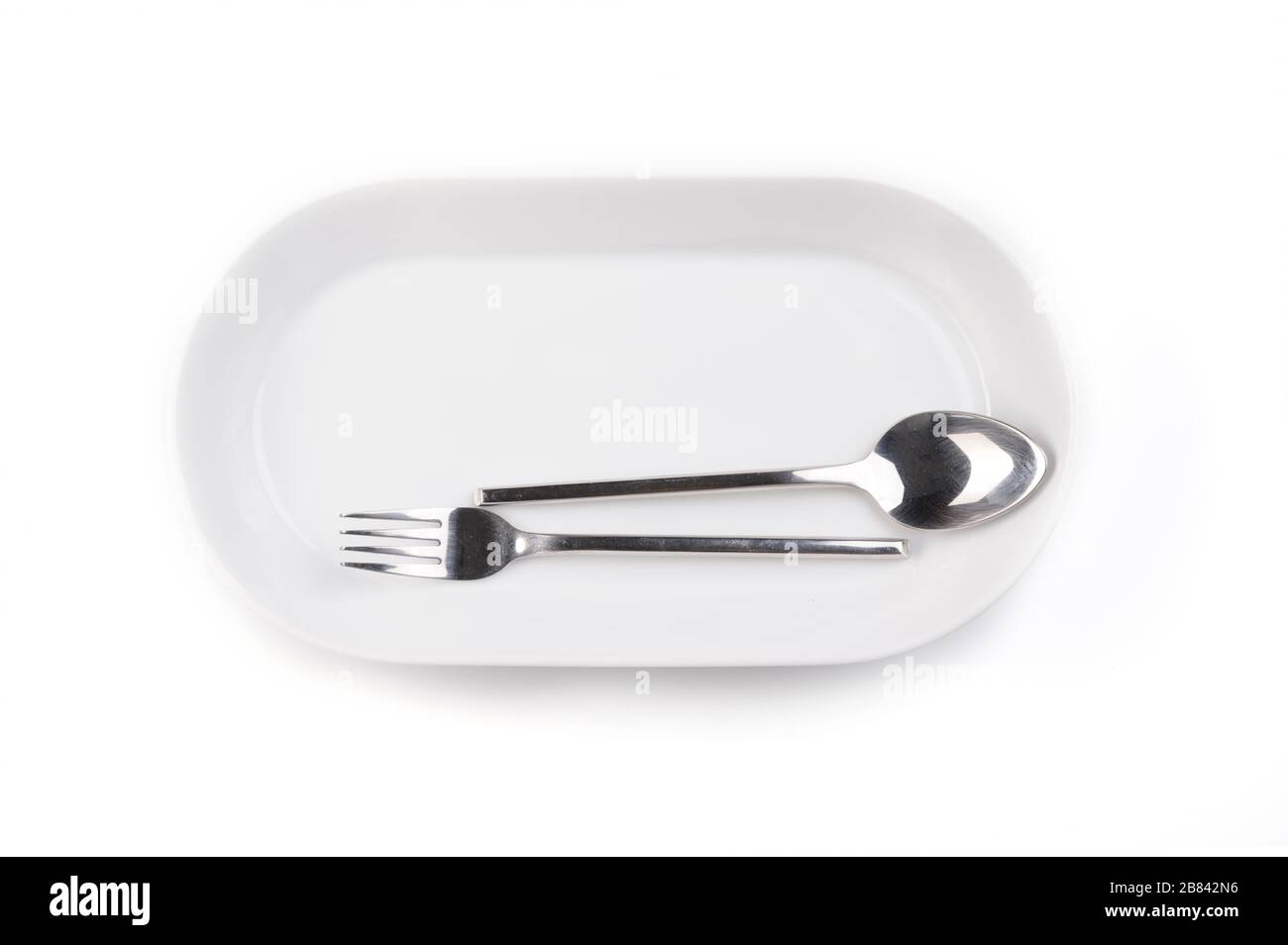 The isolate white kitchen set of plate, spoon, and folk for meal at ...