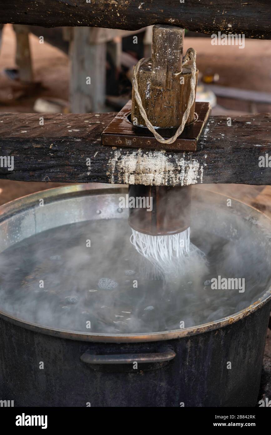 Rice mash is pressed to create rice noodles. Angkor Wat, Siem Reap ...