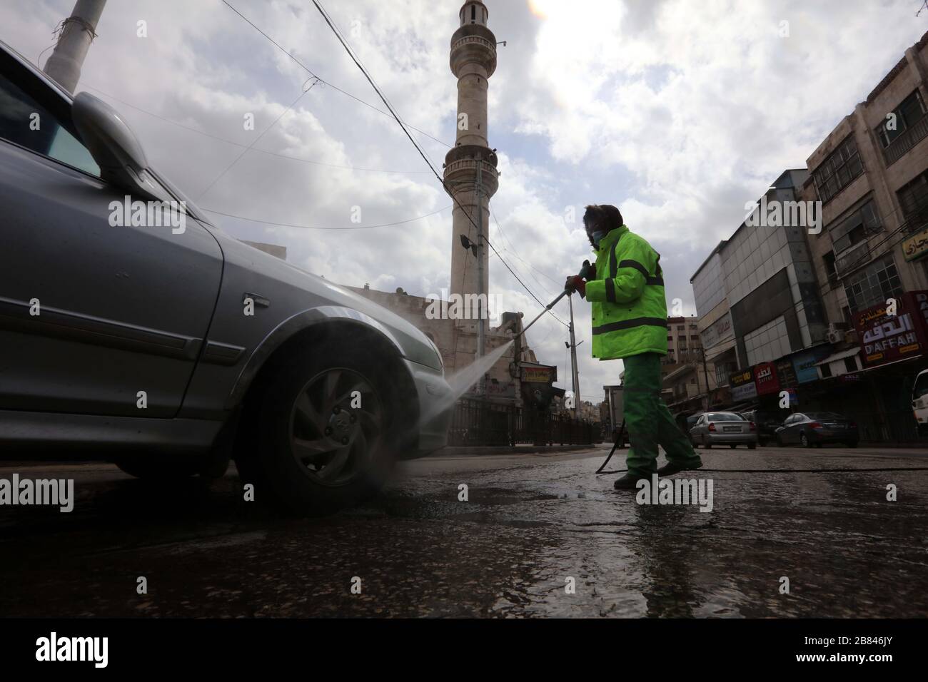 Amman, Jordan. 19th Mar, 2020. A cleaner sterilizes a car in downtown ...