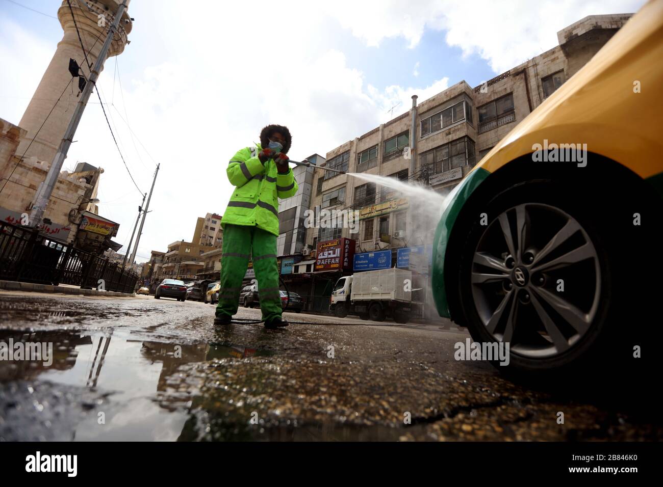 Amman, Jordan. 19th Mar, 2020. A cleaner sterilizes a car in downtown ...
