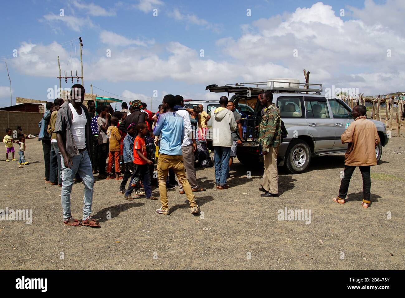Locals gathering at the Arrival of a Tour Group at El Sod Crater Stock ...