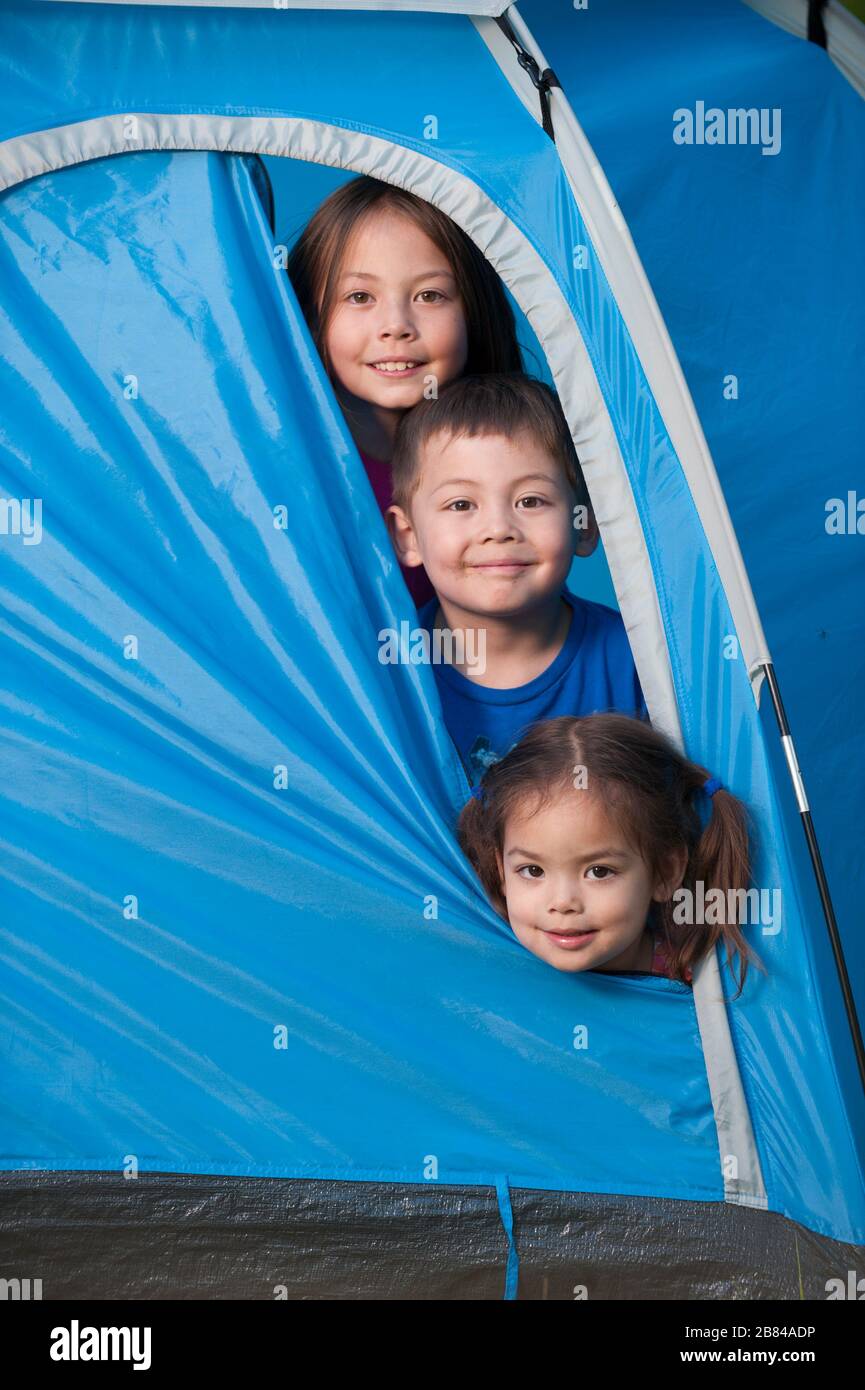 children in a tent / they are playing around in / and having fun with ...
