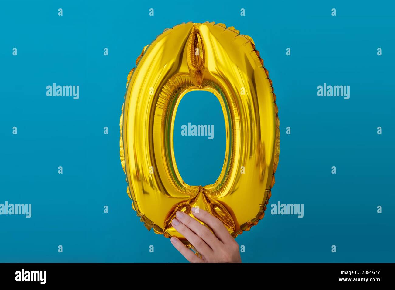Gold foil number o 0 zero celebration balloon Stock Photo - Alamy