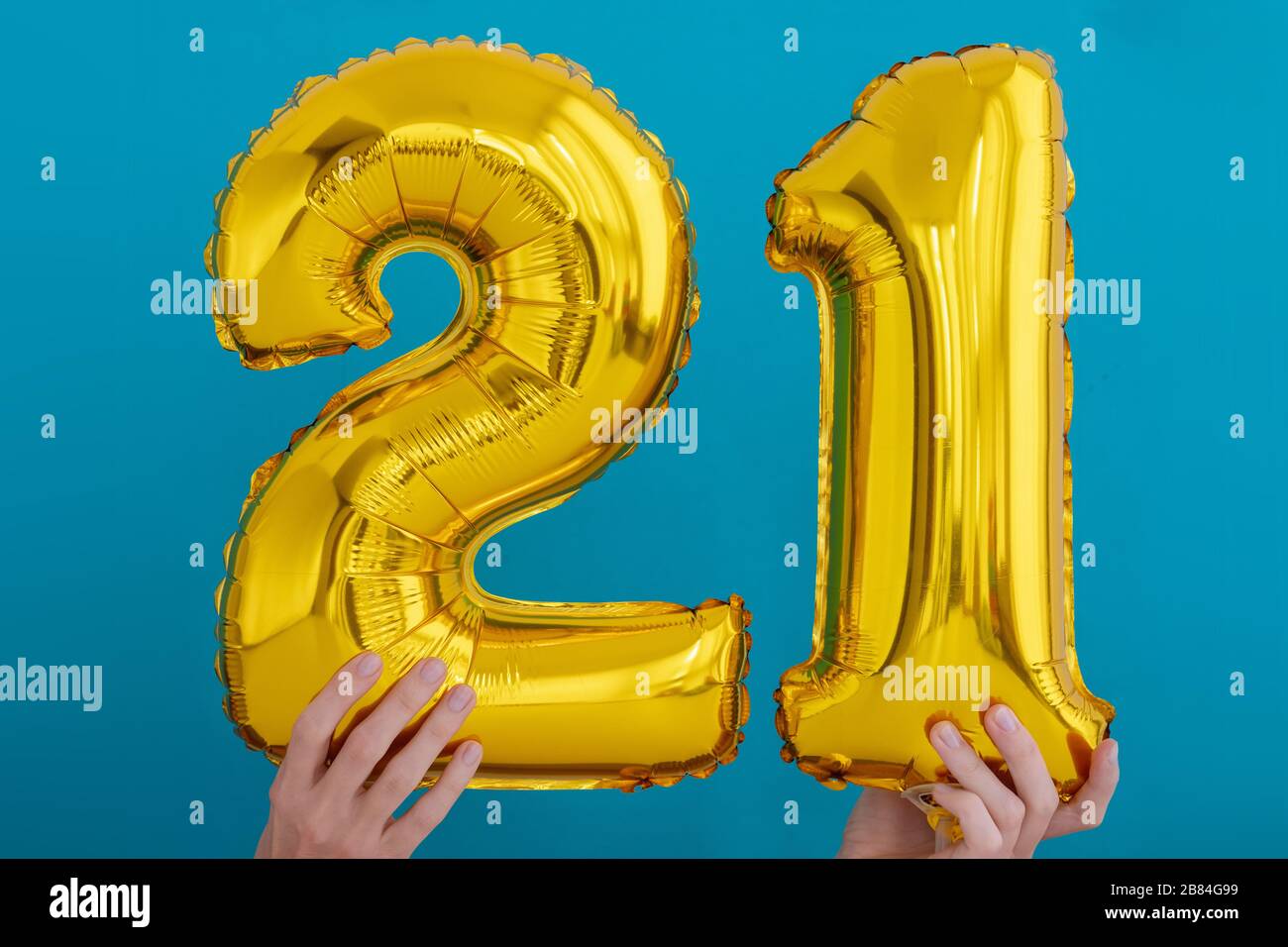 Gold foil number 21 celebration balloon Stock Photo - Alamy