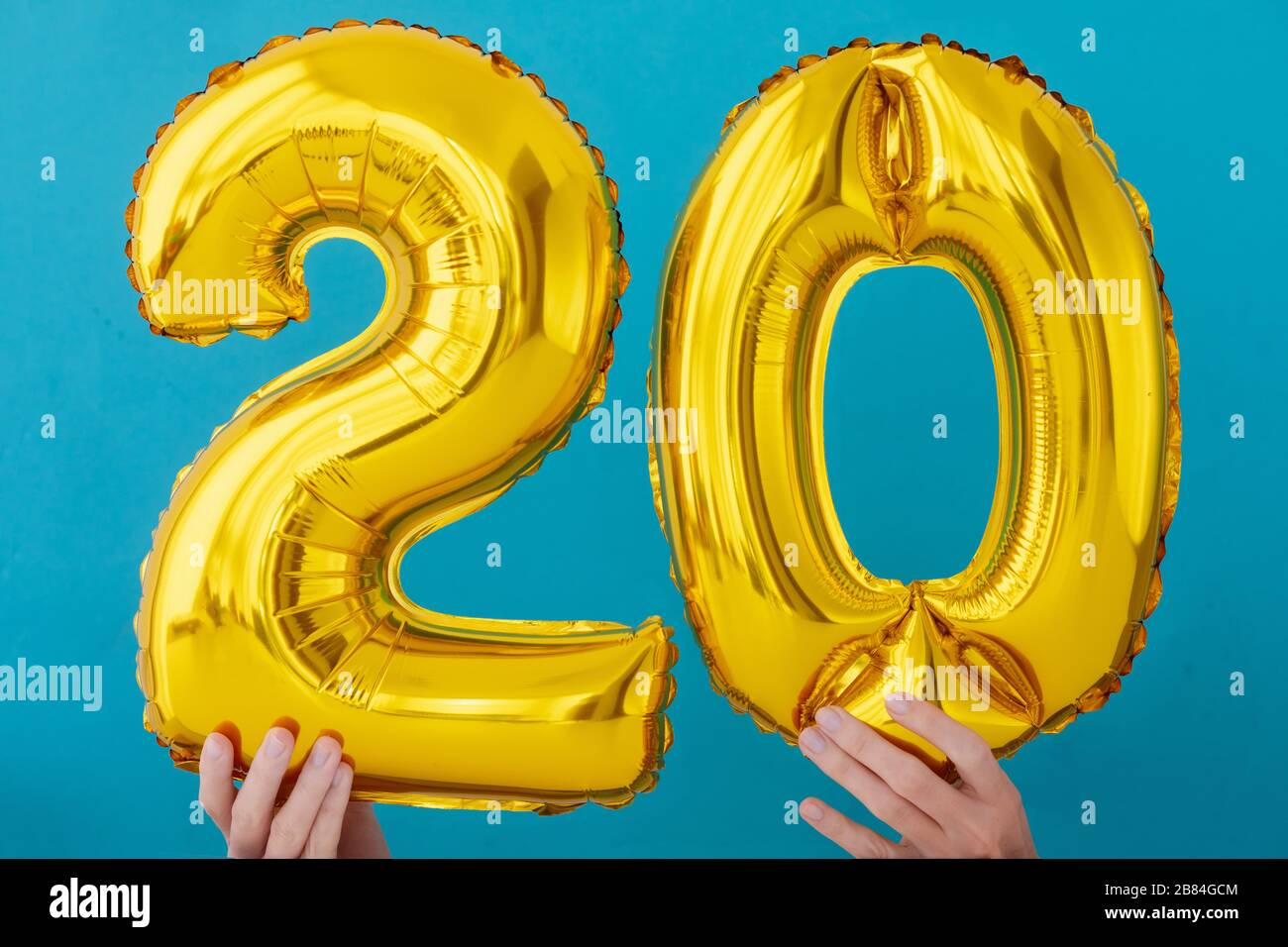 Gold foil number 20 celebration balloon Stock Photo - Alamy