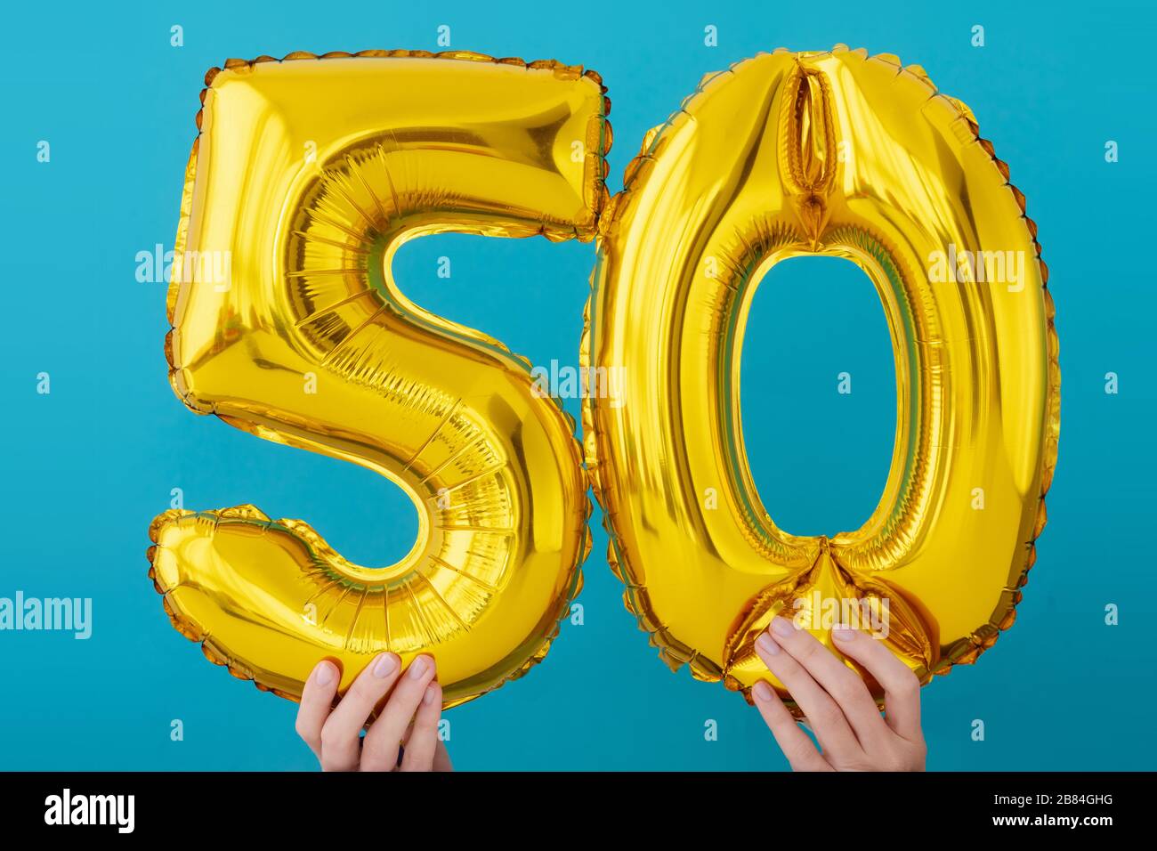 Gold foil number 50 celebration balloon Stock Photo - Alamy