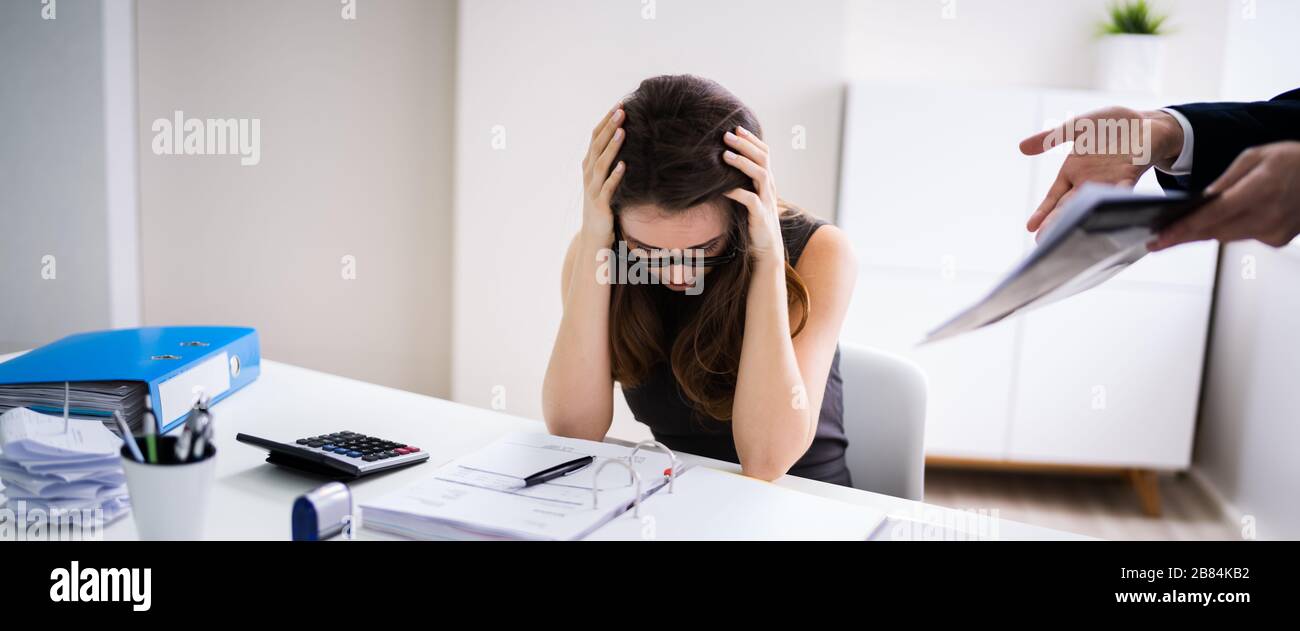 Boss Showing Document To Frustrated Female Worker In Office Stock Photo ...