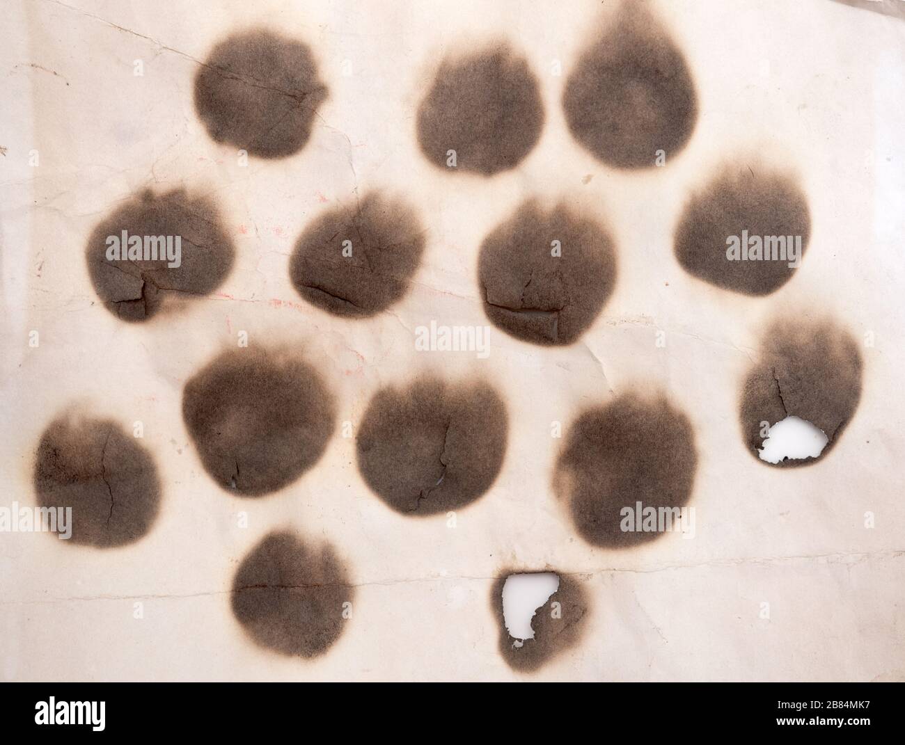 Burnt spots on a paper Stock Photo - Alamy