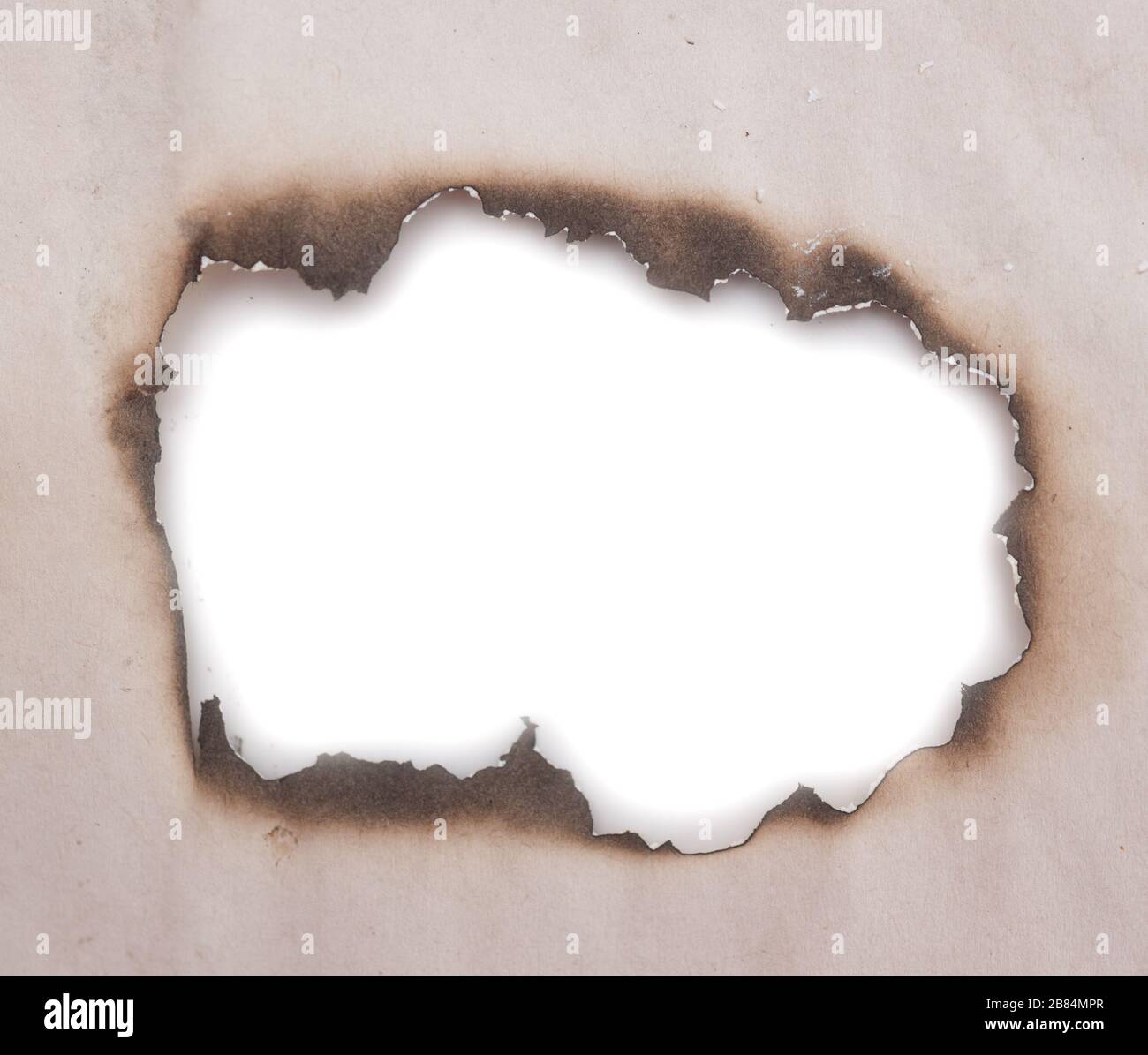 Burnt hole in a paper isolated on white background Stock Photo - Alamy