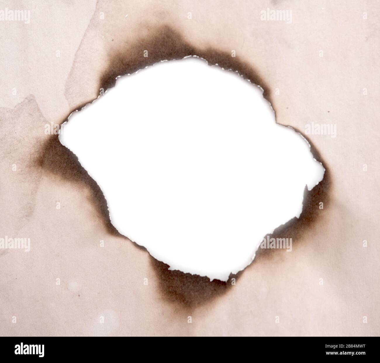 Burnt hole in a paper isolated on white background Stock Photo - Alamy