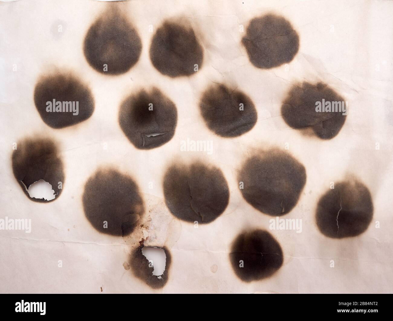 Burnt spots on a paper Stock Photo - Alamy