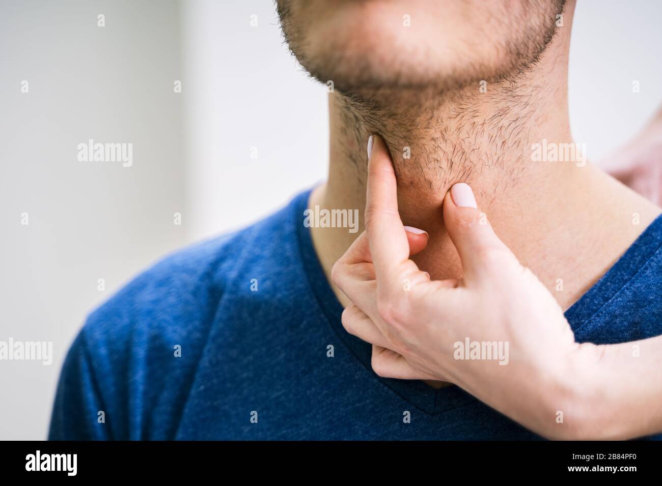 Doctor touching neck patient in hi-res stock photography and images - Alamy