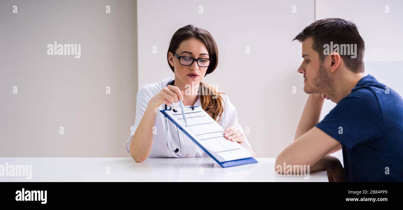 Male Patient Looking At Test Results Held By Doctor Stock Photo - Alamy