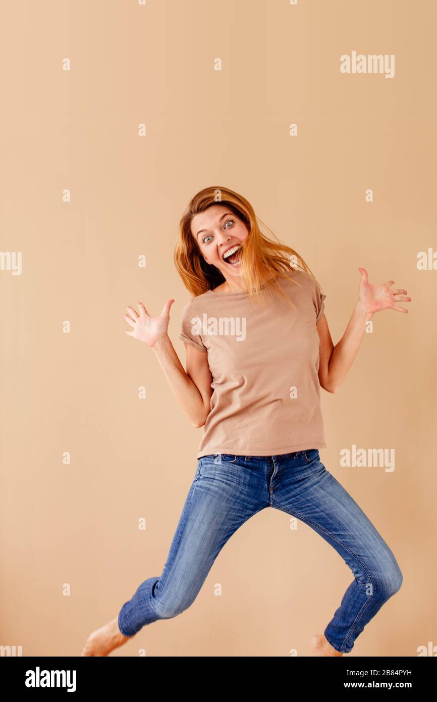 Portrait happy young woman jumping the air hi-res stock photography and ...