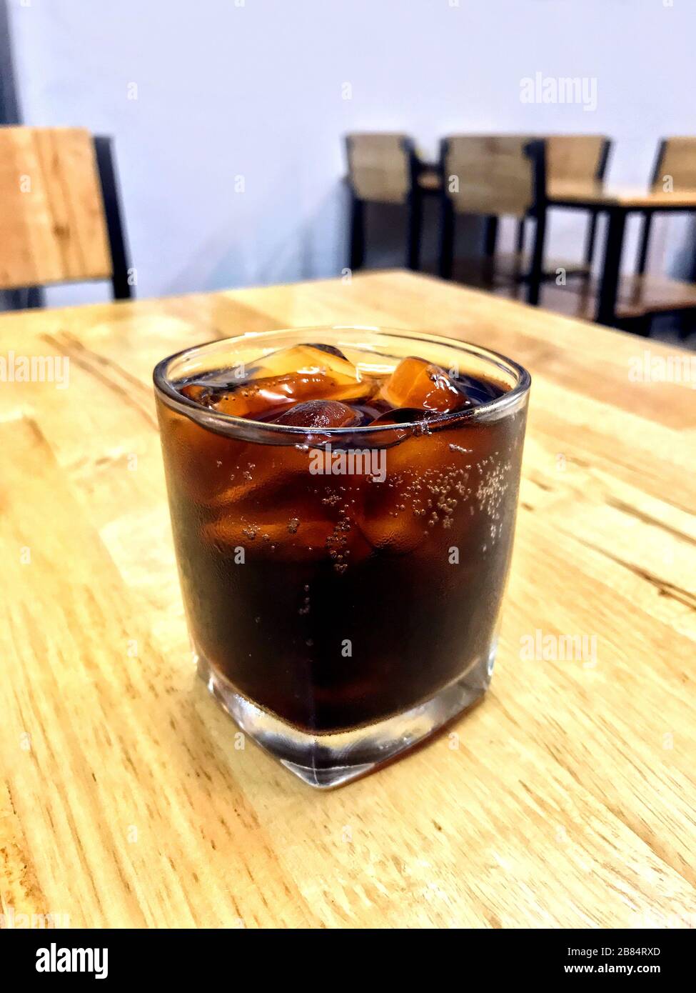 Cola in glass ice, Pouring cola from glass bottles drinks to a glass ...
