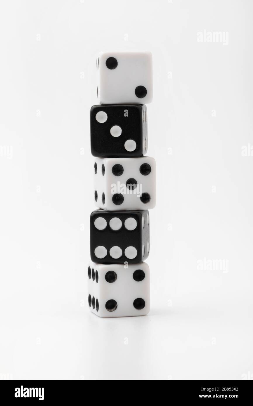 A small column of black and white dice Stock Photo - Alamy