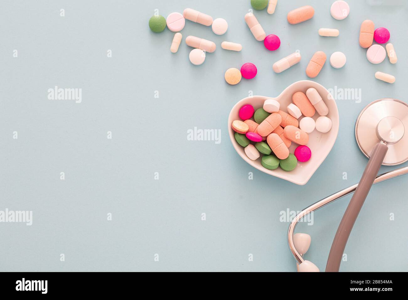 Heart disease treatment. Pills, tablets capsules and stethoscope on ...