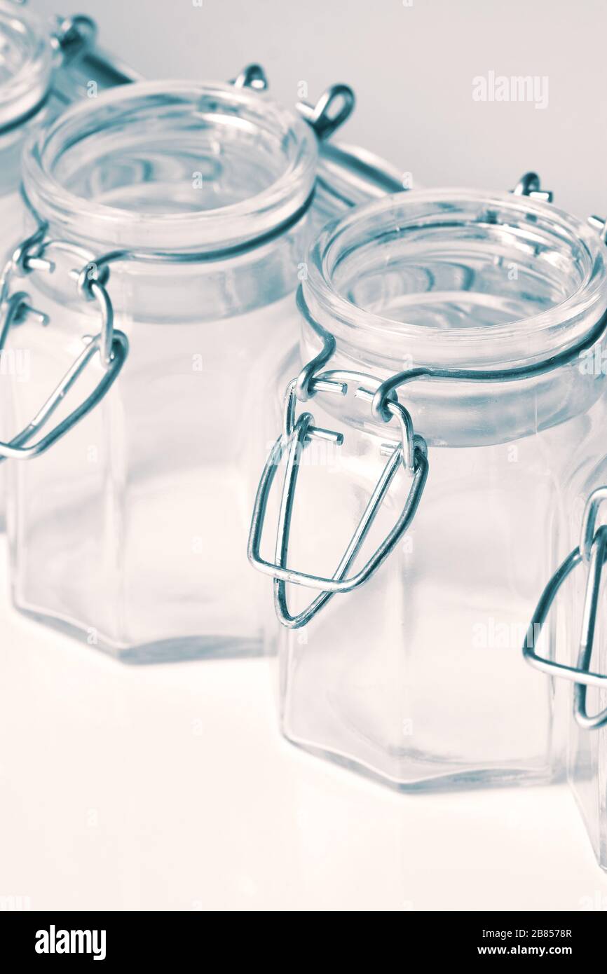 Empty glass food storage jars with a clip top seal isolated. With ...