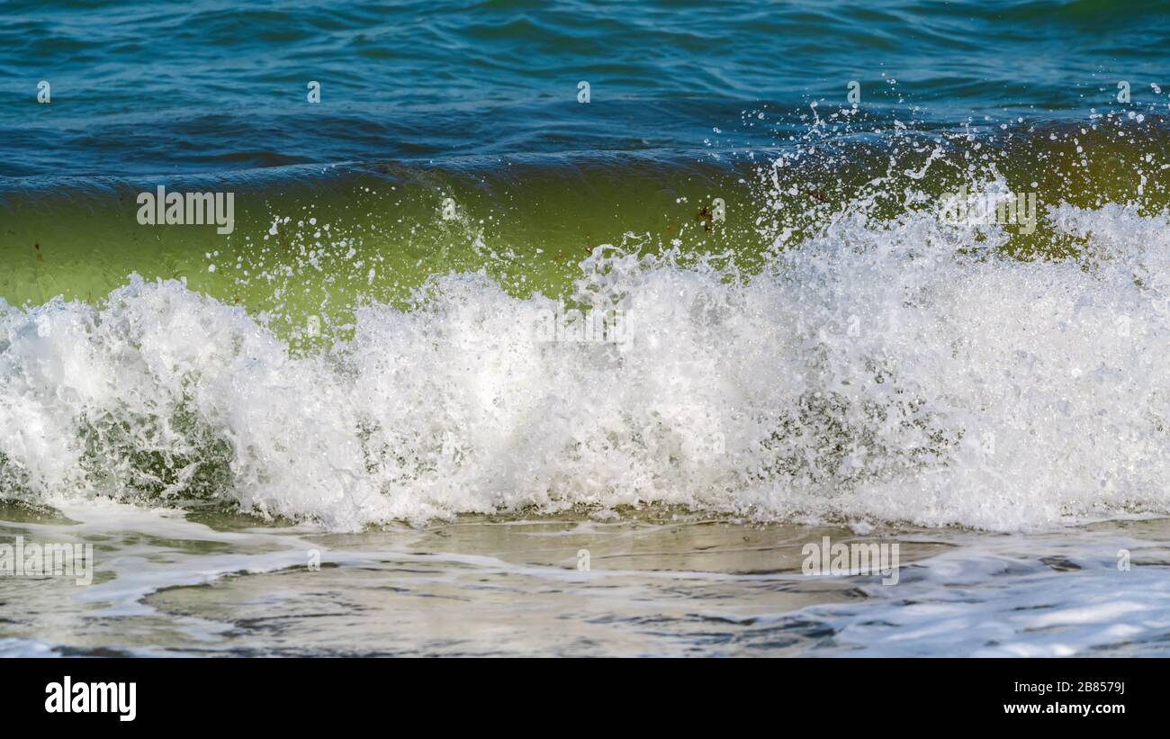 Splashing big waves on the beach Stock Photo - Alamy