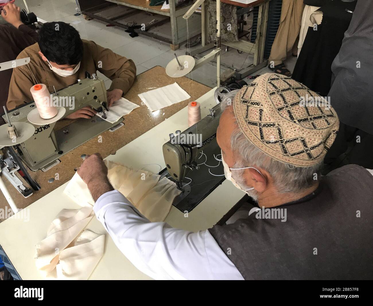 Kandahar, Afghanistan. 19th Mar, 2020. Afghan men make masks to donate ...