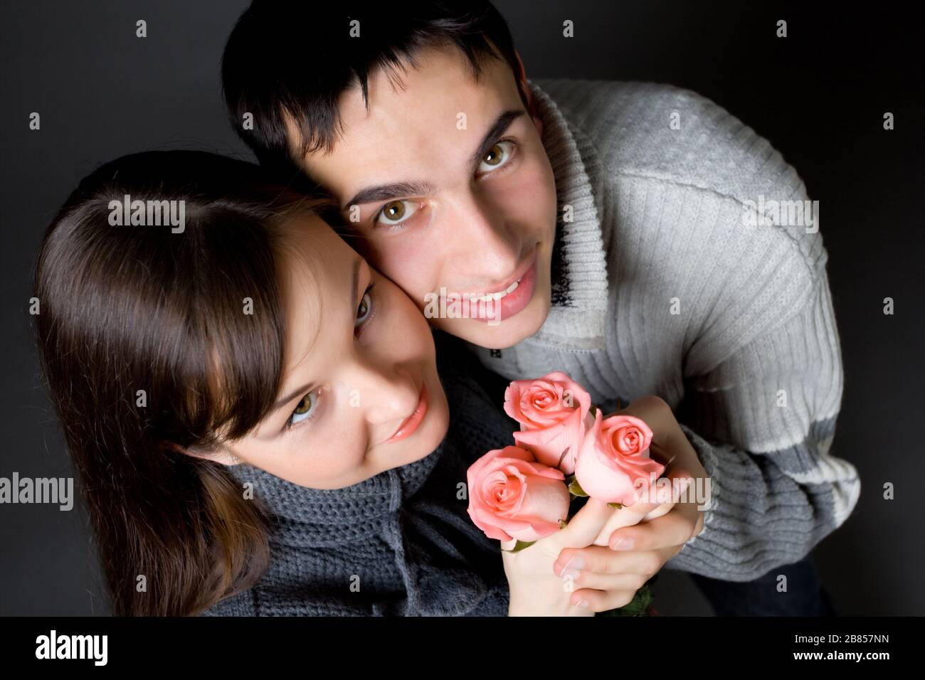 Top view of a charming young couple man and woman hugging and holding ...