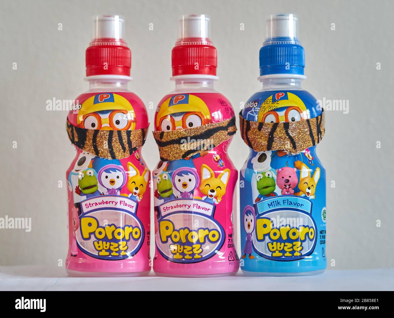 Colourful bottles of Korean flavoured milk, with face masks, concept ...