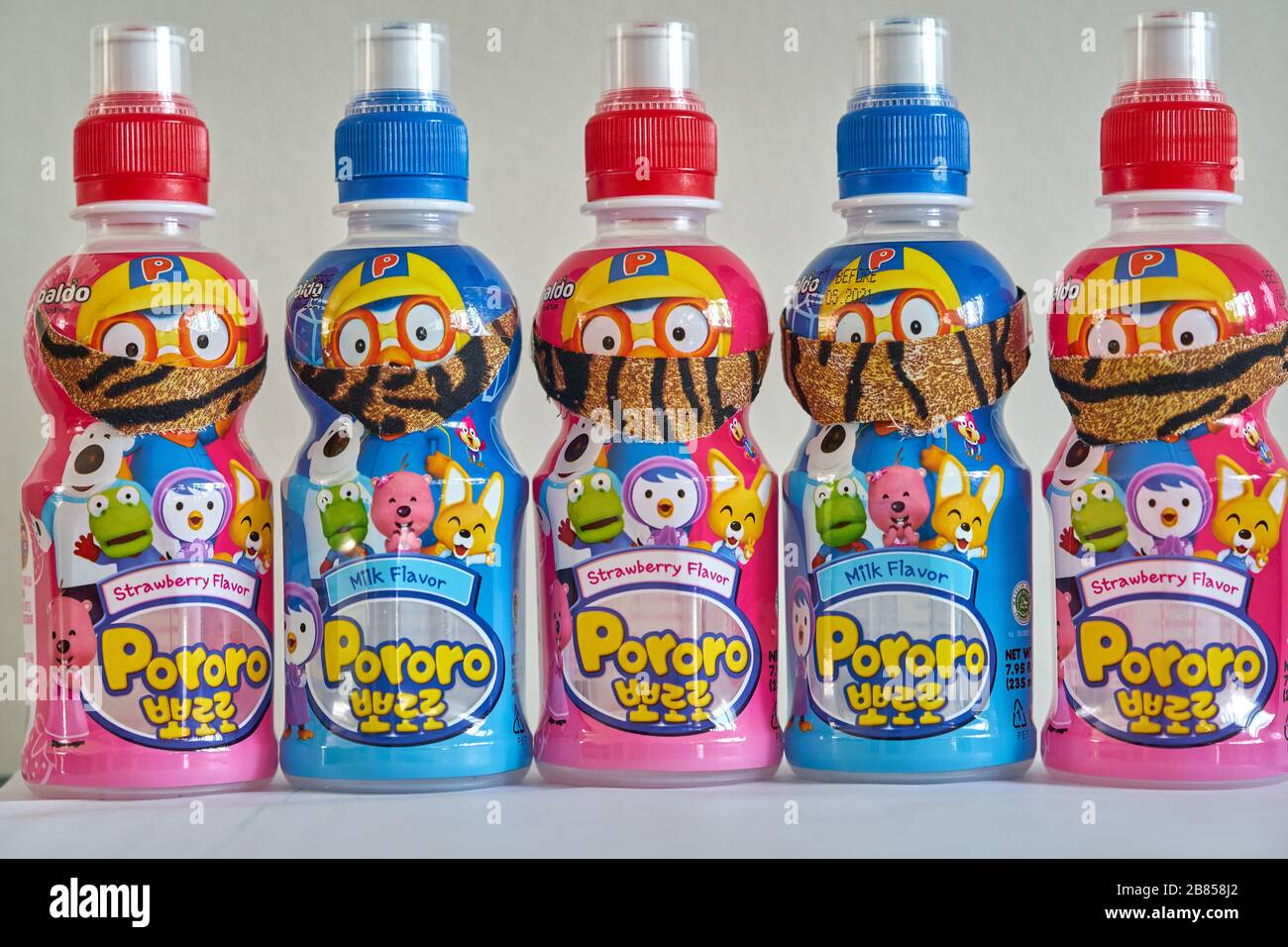 Colourful bottles of Korean flavoured milk, with face masks, concept ...