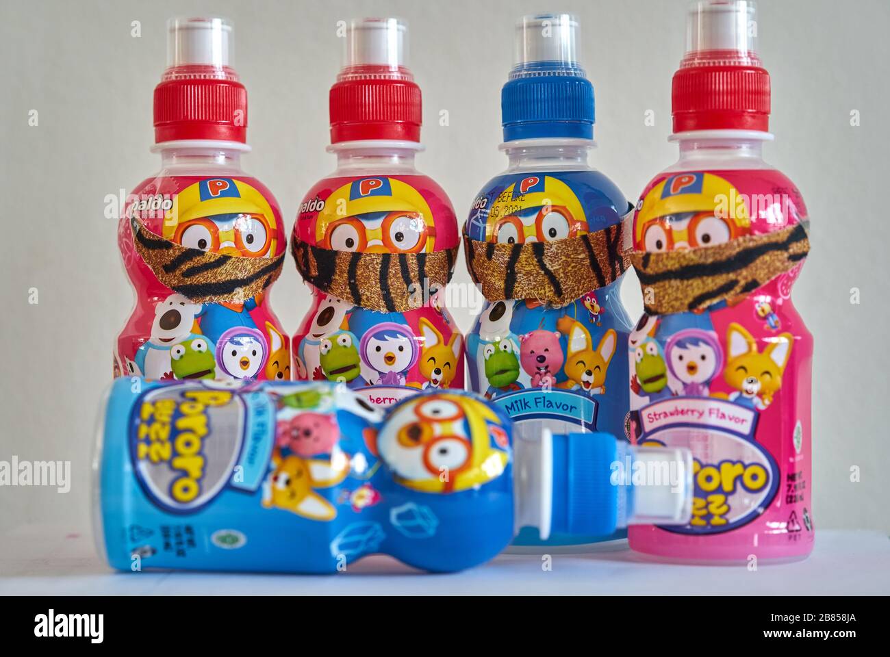 Colourful bottles of Korean flavoured milk, with face masks, concept ...