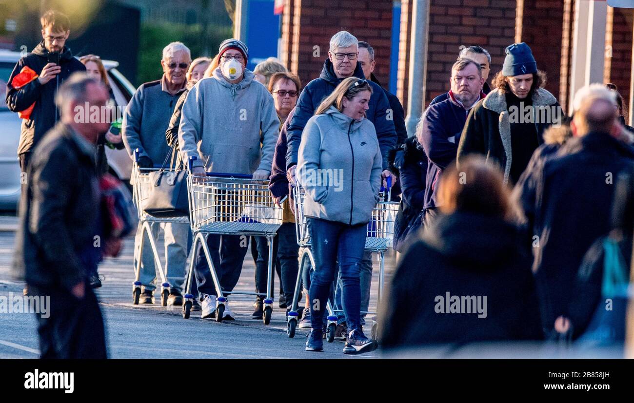Customers form a queue at the Tesco store in Mather Avenue, Liverpool ...