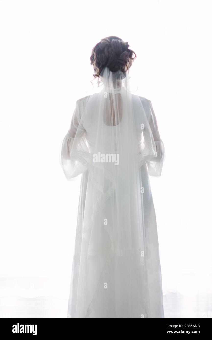 Back of bride, standing against the big window Stock Photo - Alamy