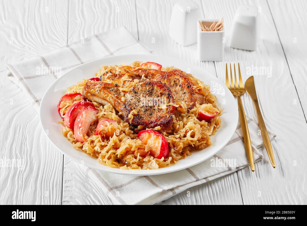 close-up of delicious juicy Pork rib Chops with Sauerkraut and Apples ...