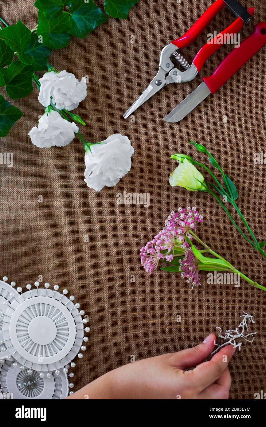 The hands of young woman florist making bouquet of flowers Stock Photo ...