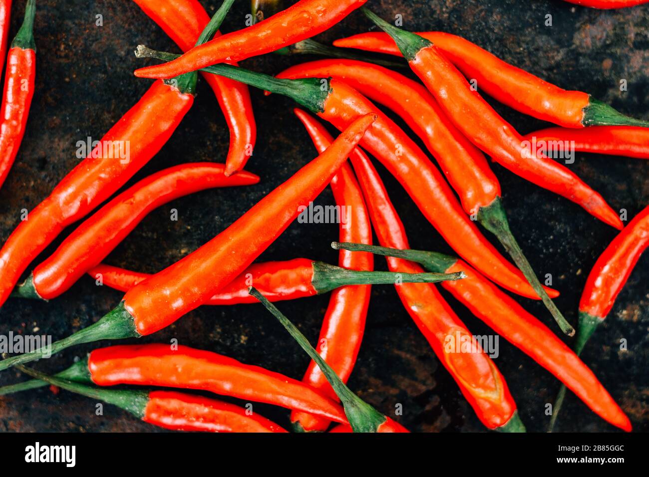 Red hot chili peppers over rustic surface - fresh and organic Stock ...