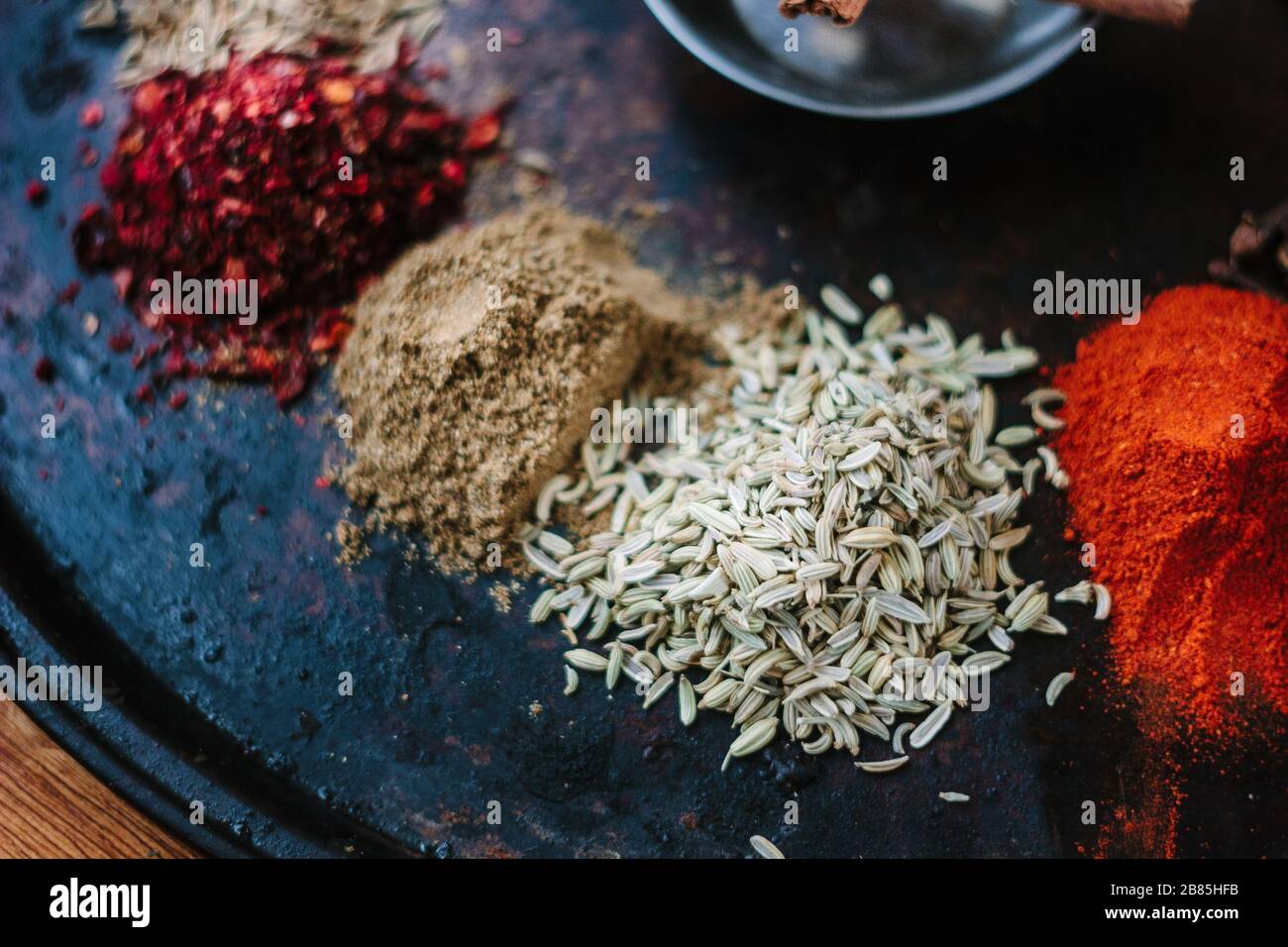 Set of different spices over black metal plate Stock Photo - Alamy