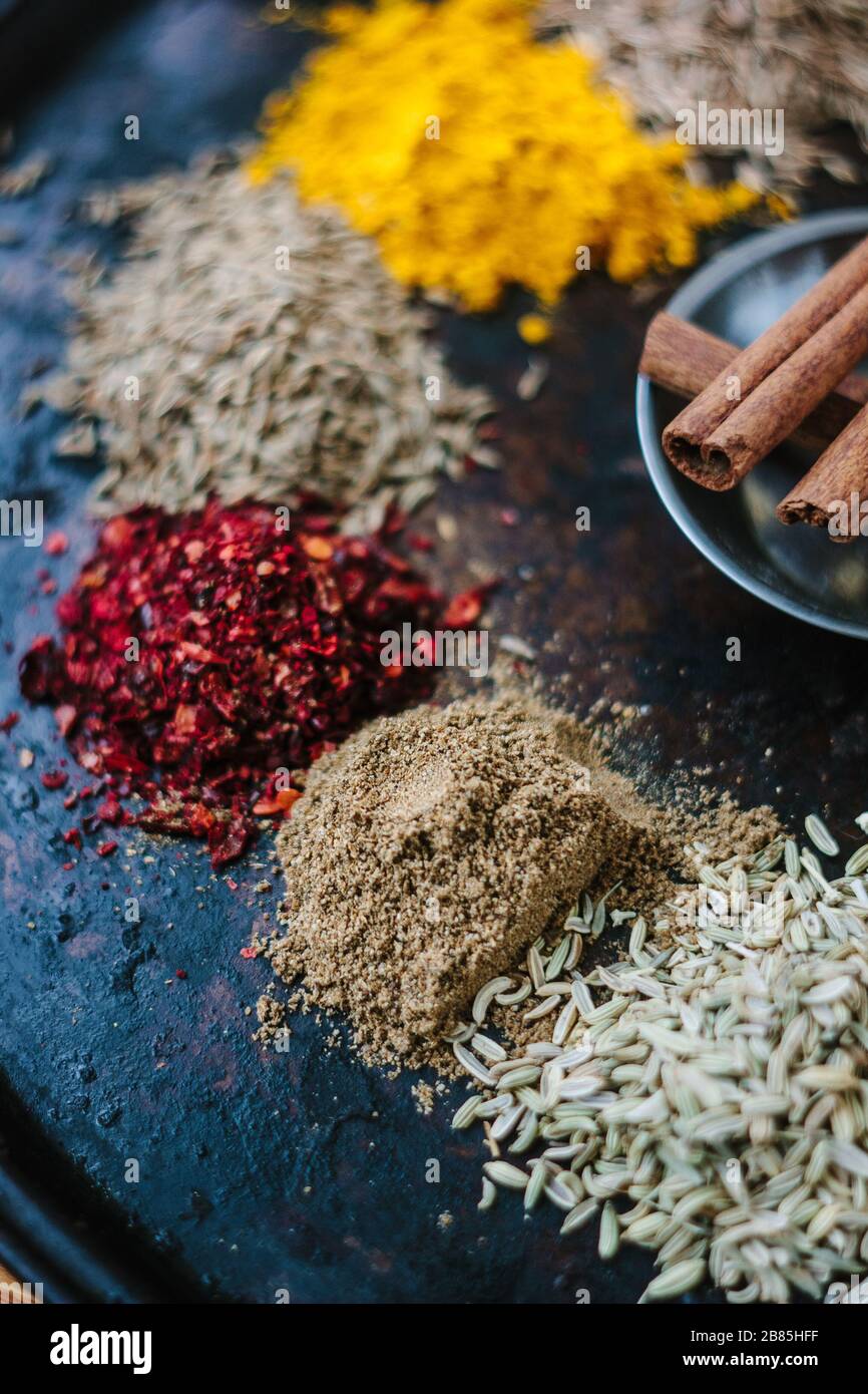 Grounded pepper surrounded by spices over black surface Stock Photo - Alamy