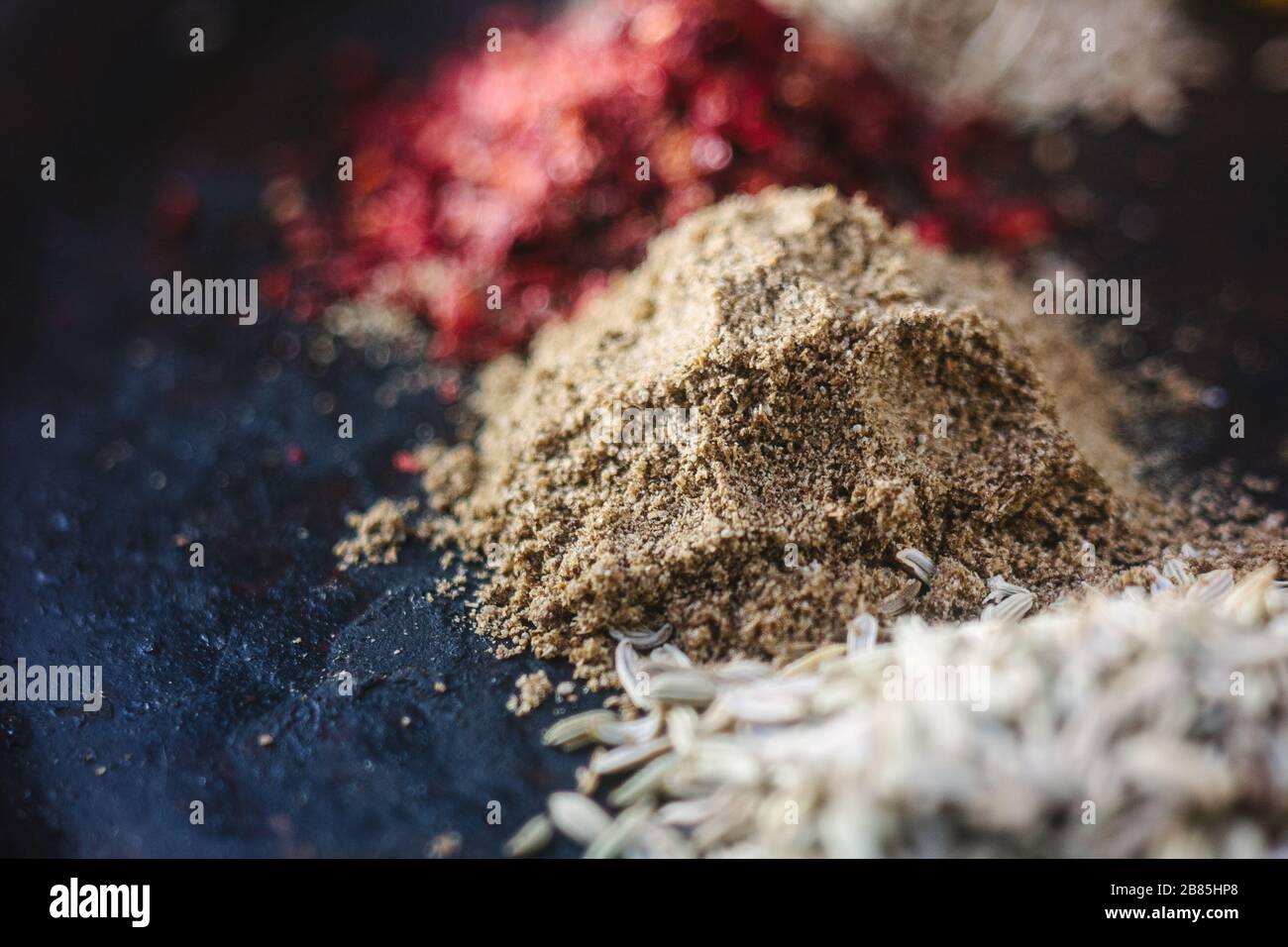 Grounded pepper surrounded by spices over black surface Stock Photo - Alamy