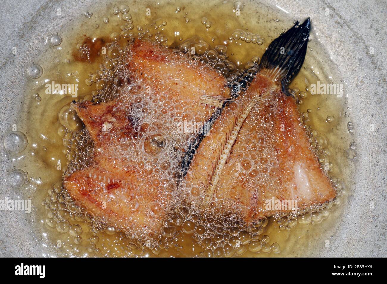 Fried fish pieces in hot oil pan, Fried fish for diet, Fish cutting ...