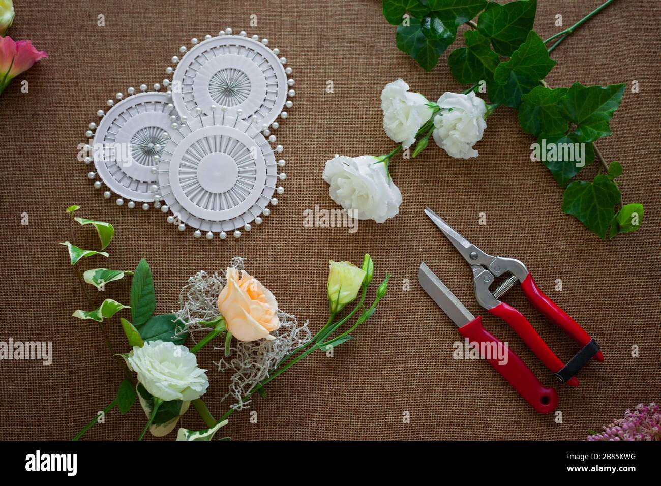 Florist workplace. Tools and accessories. Flowers, pruner, knife, pins ...