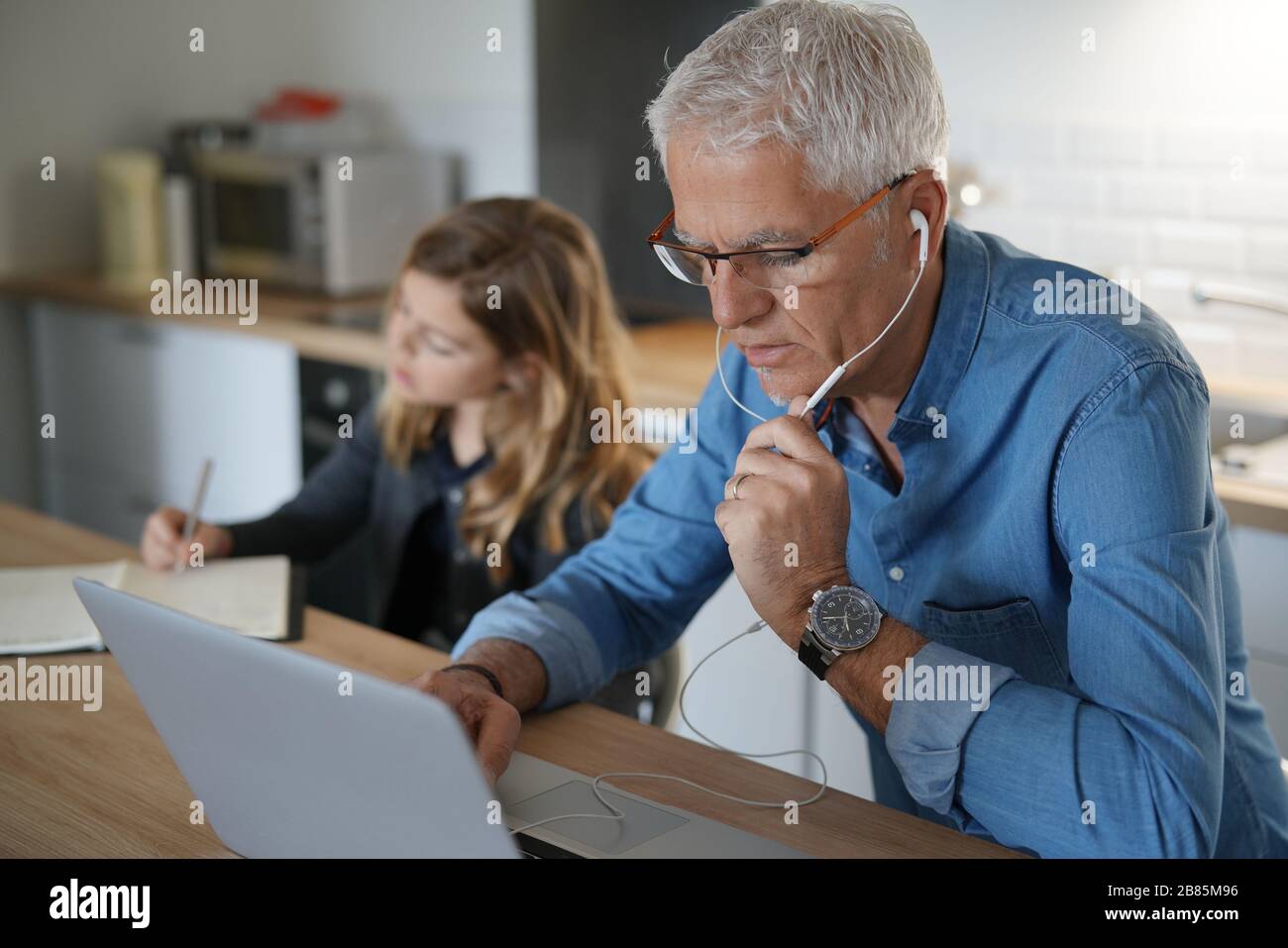 Father and school-girl working form home, telework and e-learning Stock ...